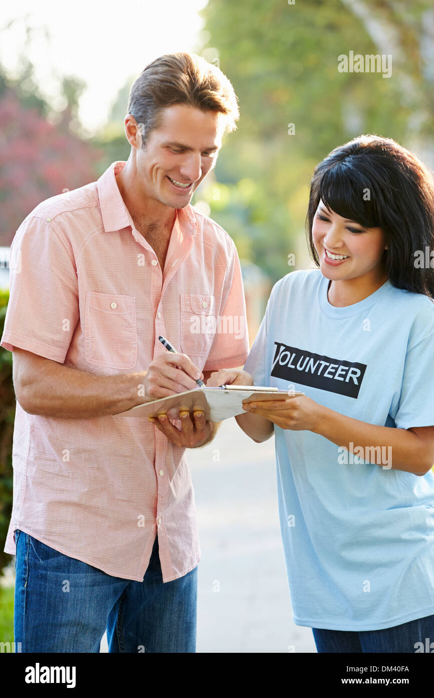 Charity Worker Collecting Sponsorship From Man In Street Stock Photo ...