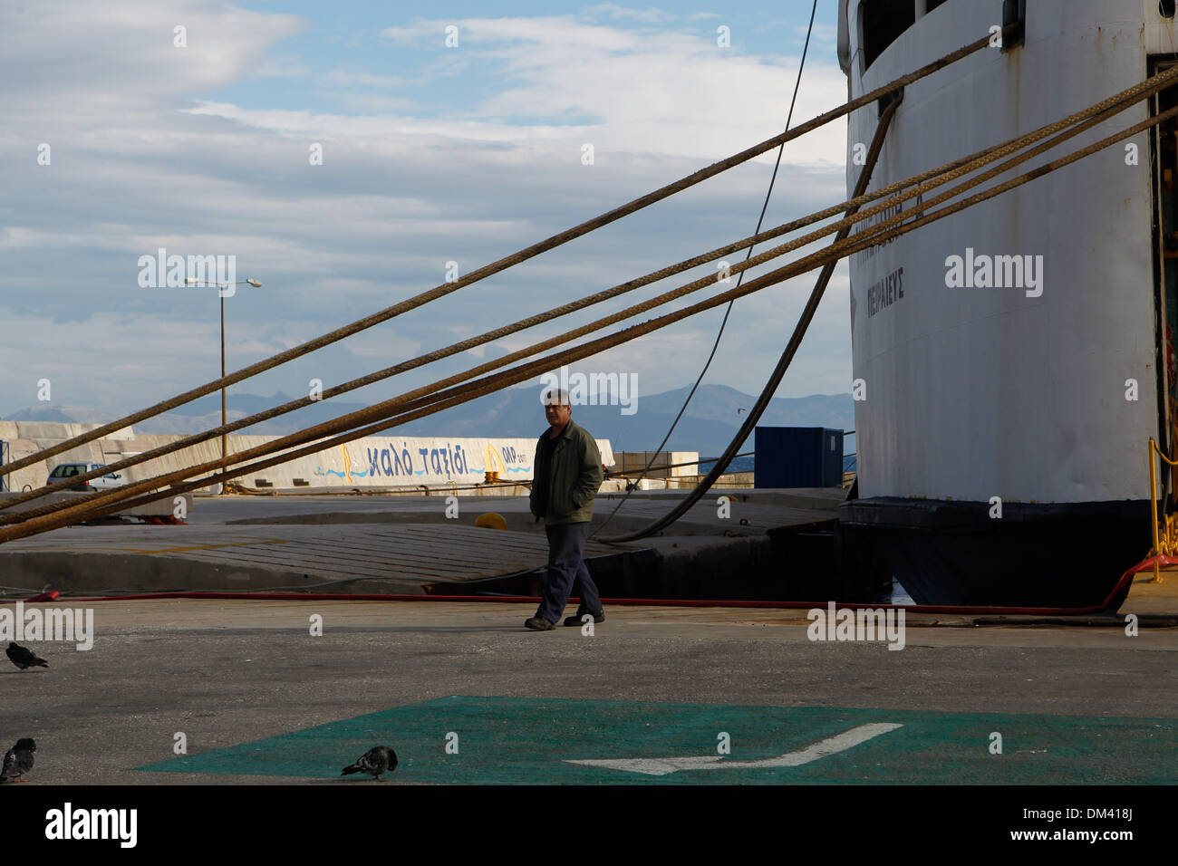 Ship crew guiding heavy duty mooring rope during docking procedure ...