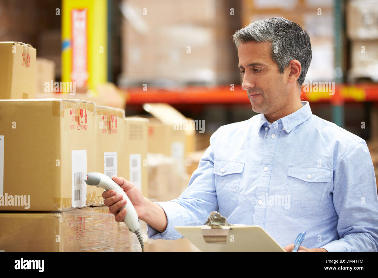 Worker Scanning Package In Warehouse Stock Photo - Alamy