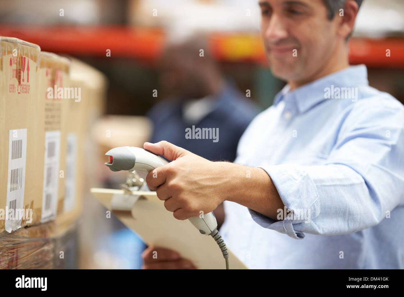 Worker Scanning Package In Warehouse Stock Photo - Alamy
