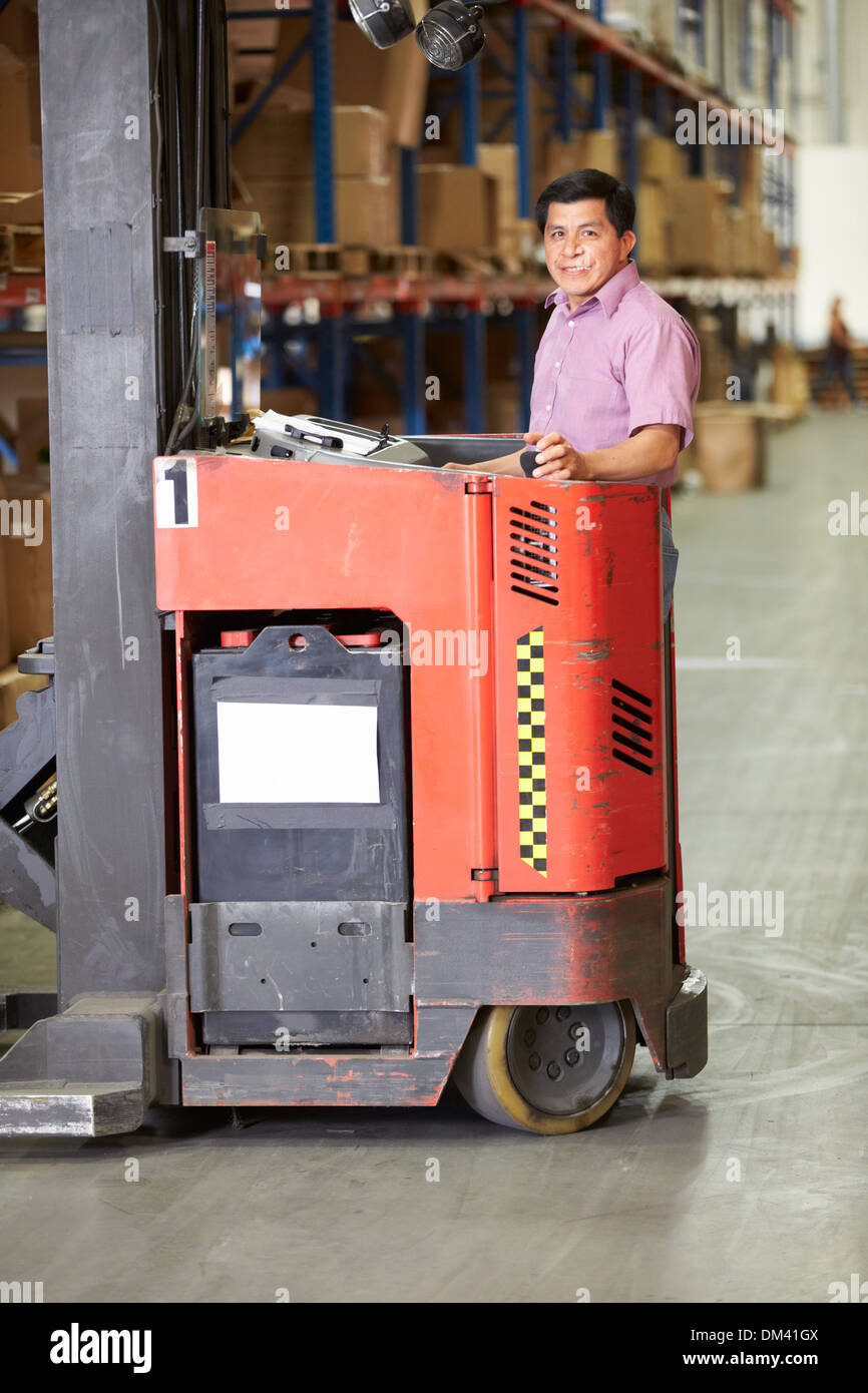 Man Driving Fork Lift Truck In Warehouse Stock Photo - Alamy