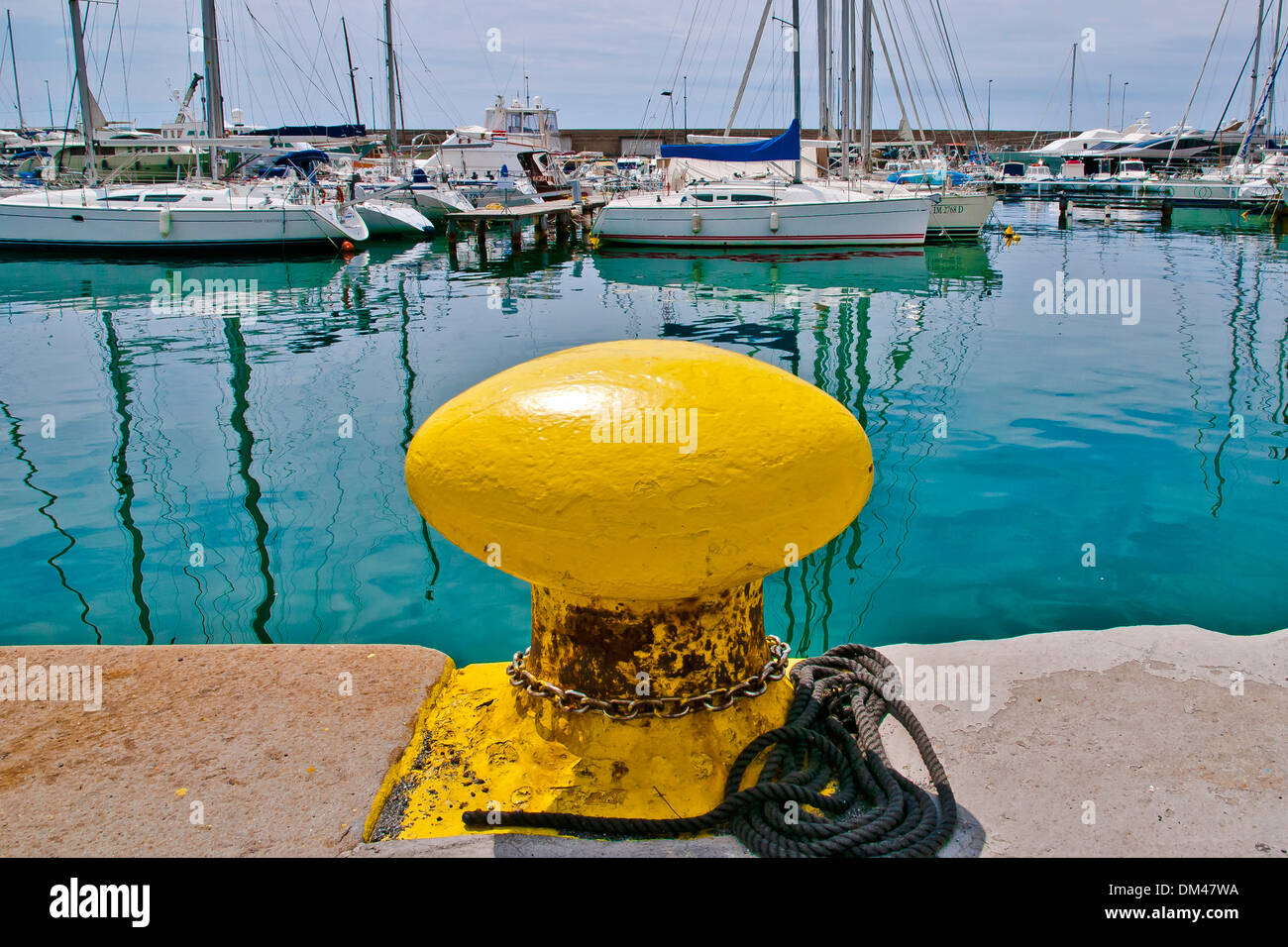 Yellow bollard and boat dock, San Remo, Italy Stock Photo - Alamy