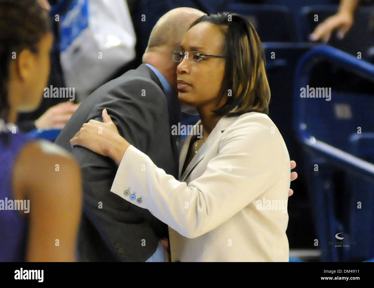 Washington head coach Tia Jackson, left, shakes hands with Gonzaga head ...