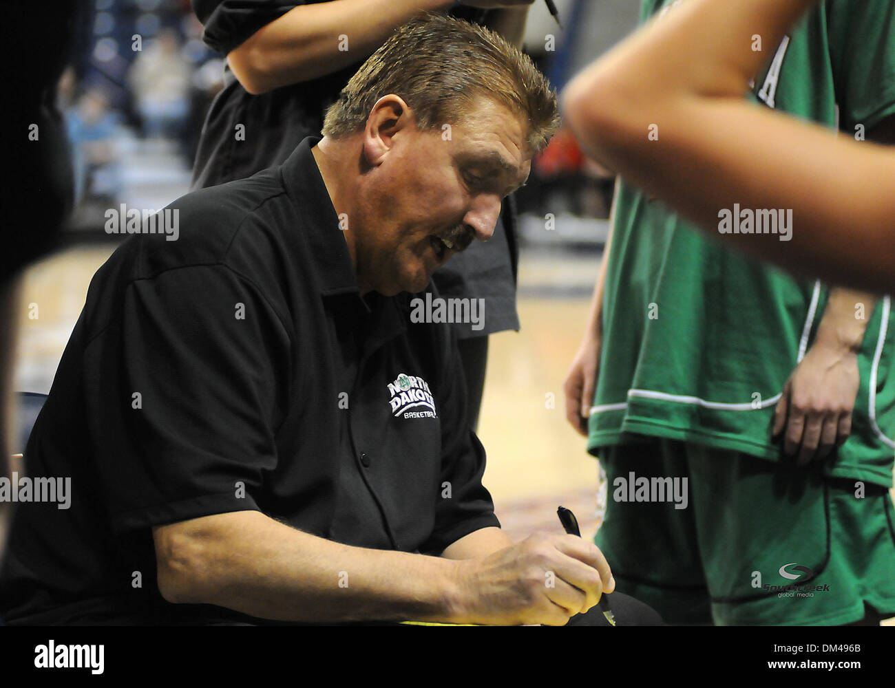 North Dakota's head coach Gene Roebuck goes over a play during a time ...