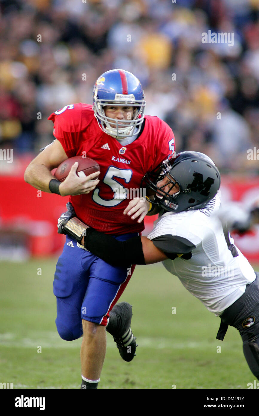 Kansas quarterback Todd Reesing (5) is brought down by Missouri ...