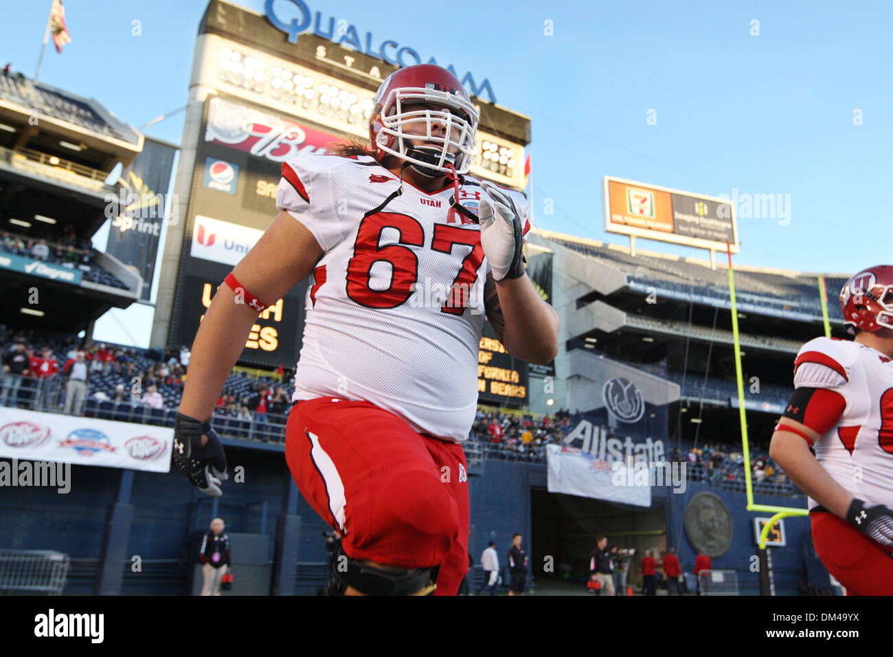 Utah offensive lineman Derek Tuimauga #67 warms up on the sideline ...