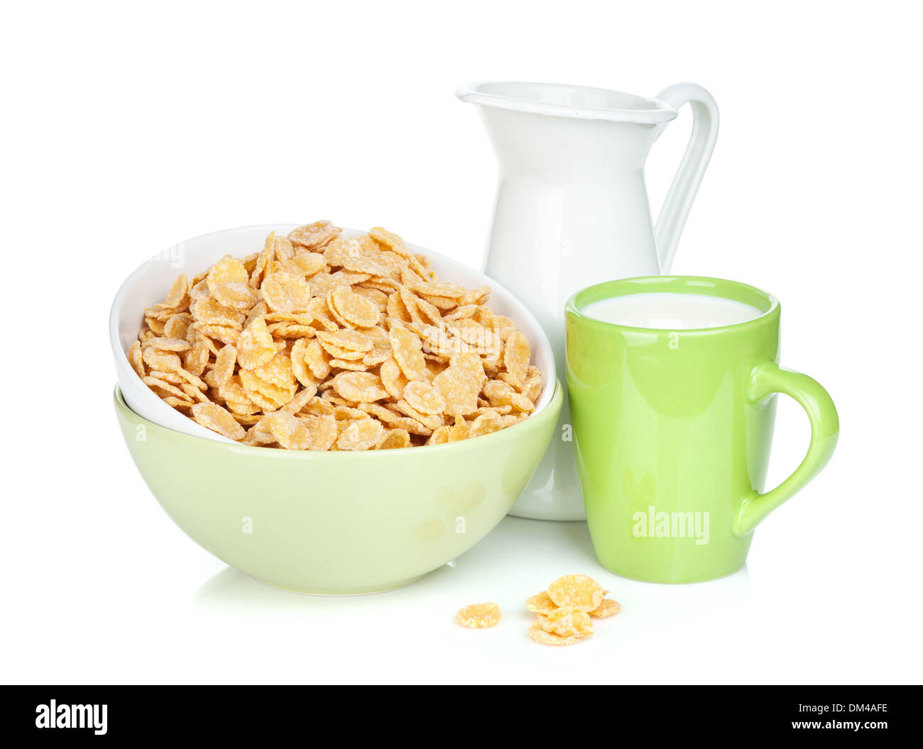 Fresh corn flakes in bowl, milk jug and cup. Isolated on white ...