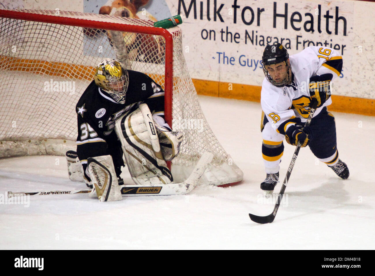 Canisius's Jason Weeks (16) takes a shot at Army's goaltender Jay Clark ...