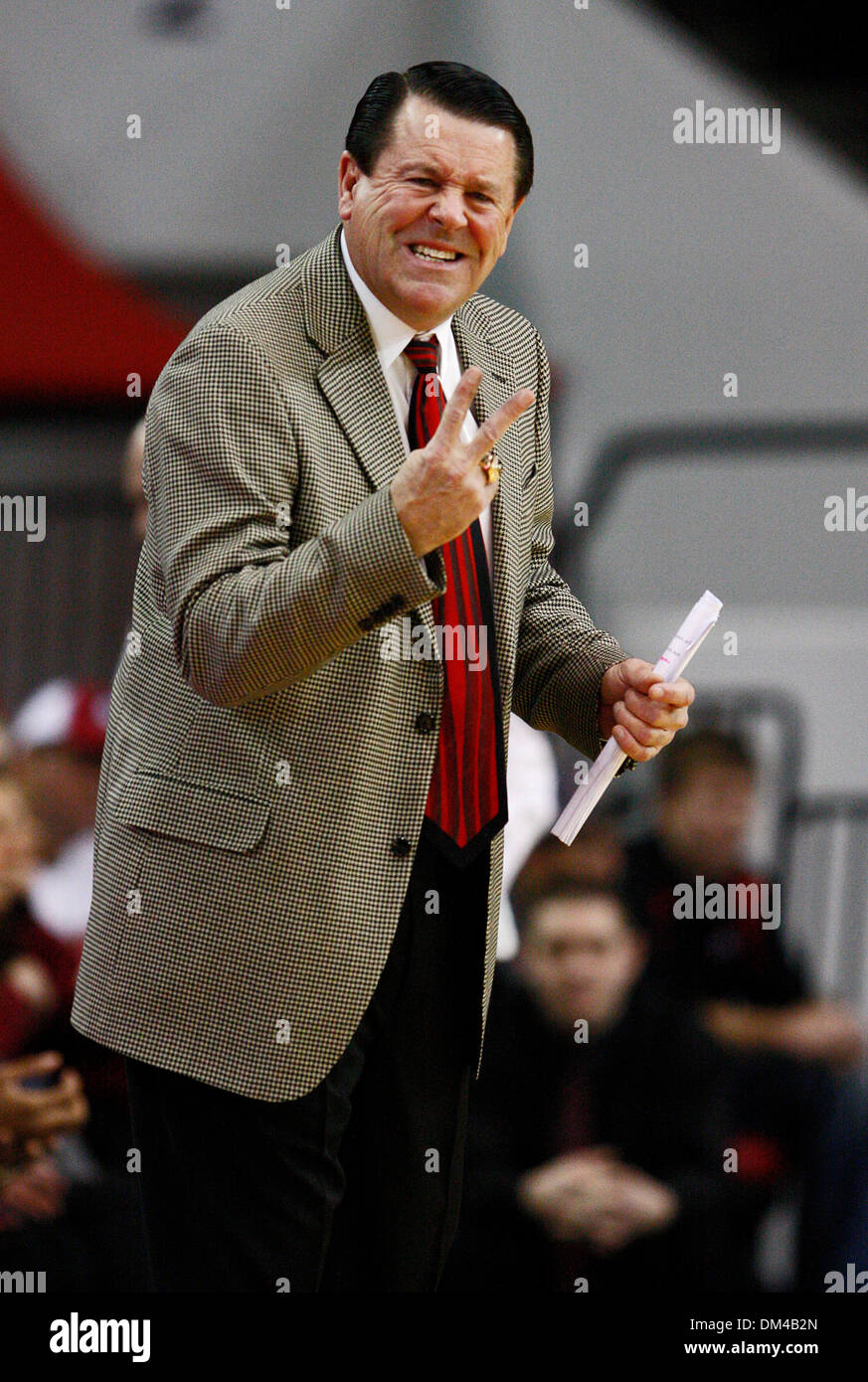 Georgia head coach Andy Landers signs to his players at the game ...
