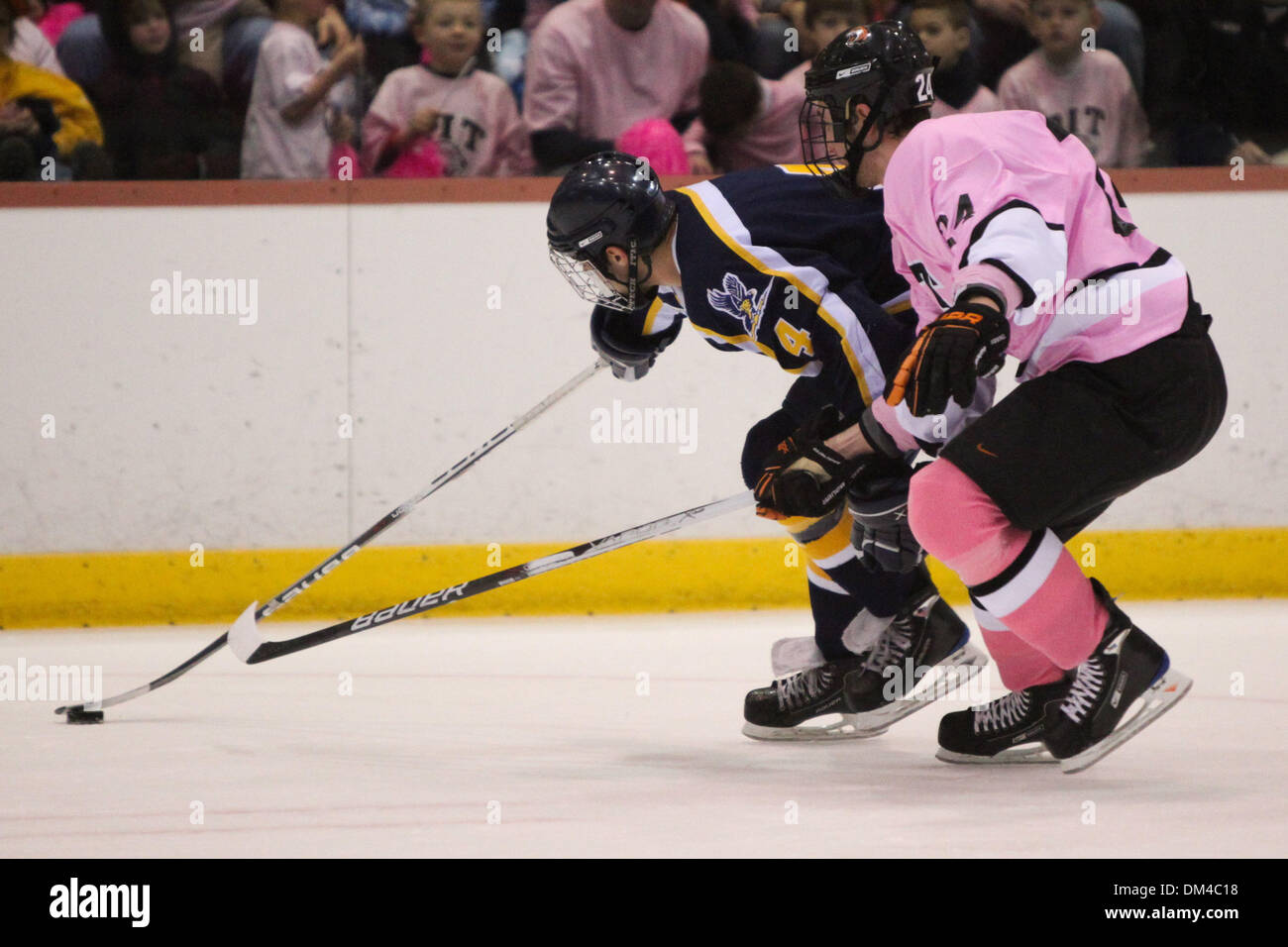 Bentley's Mike Switzer (4) and RIT's Chris Haltigin (24) go for the ...