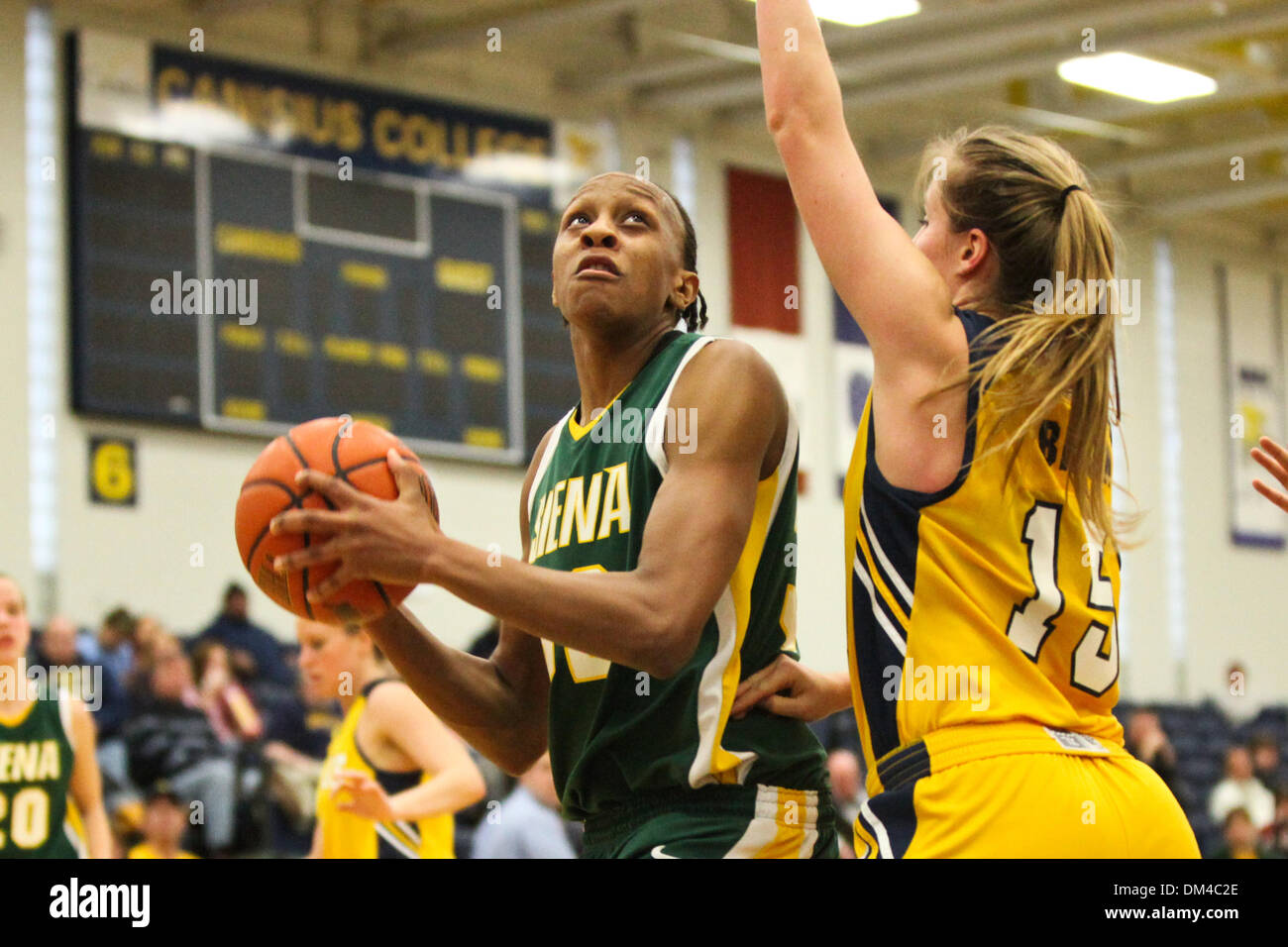 Siena's Serena Moore (32) looks for the basket as Canisus's Allison ...