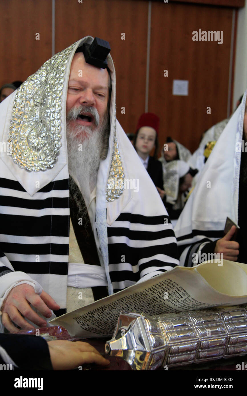 The Rabbi of the Premishlan congregation is reading the Purim Megillah ...