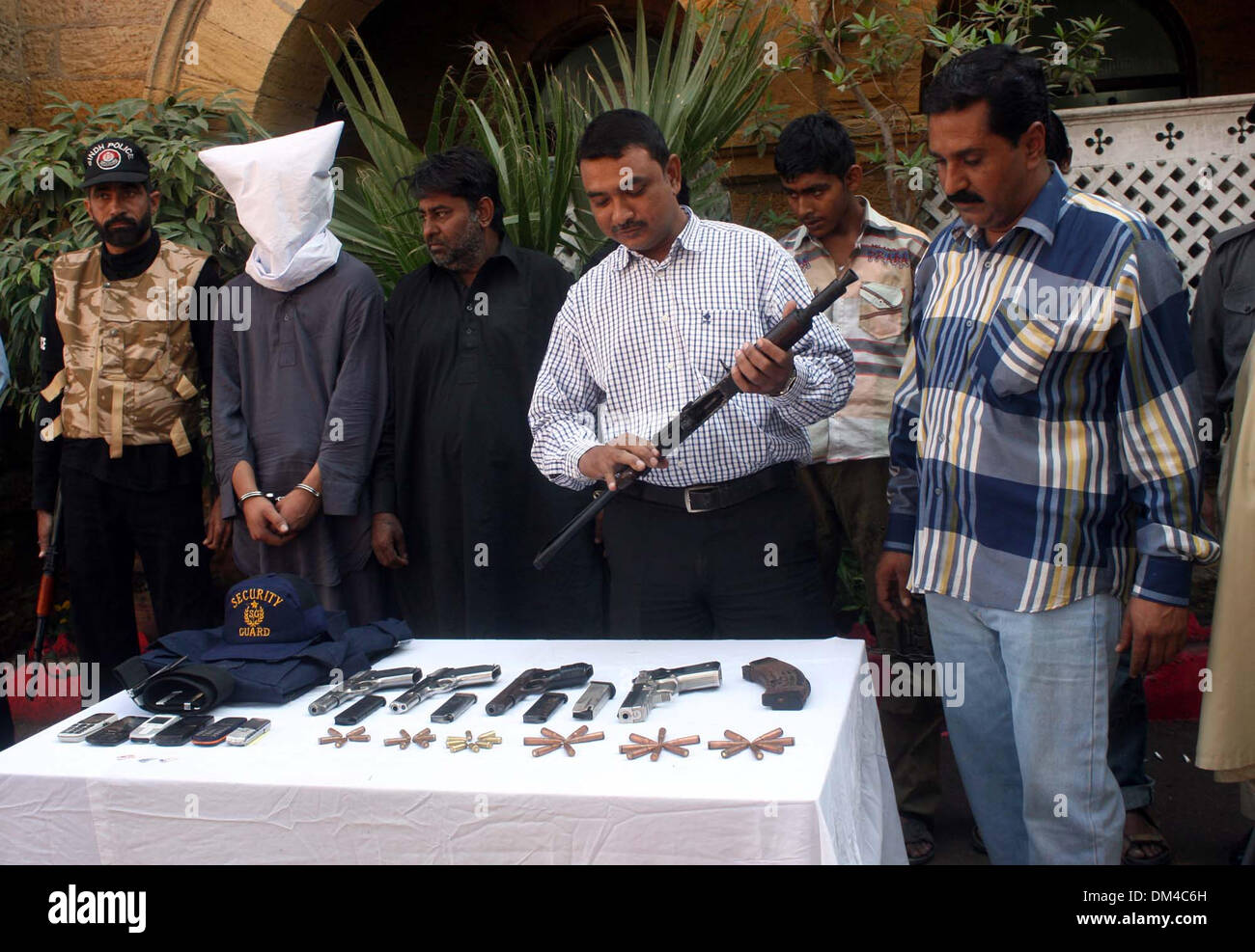 Karachi, Pakistan. 11th Dec, 2013. Police officials showing seized ...