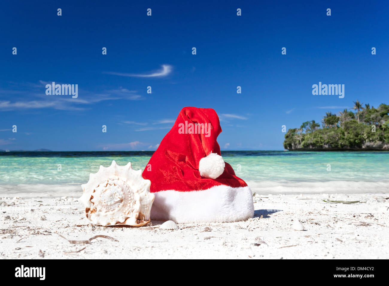 Red Santa Claus hat on beach with seashell, Travel Christmas concept ...