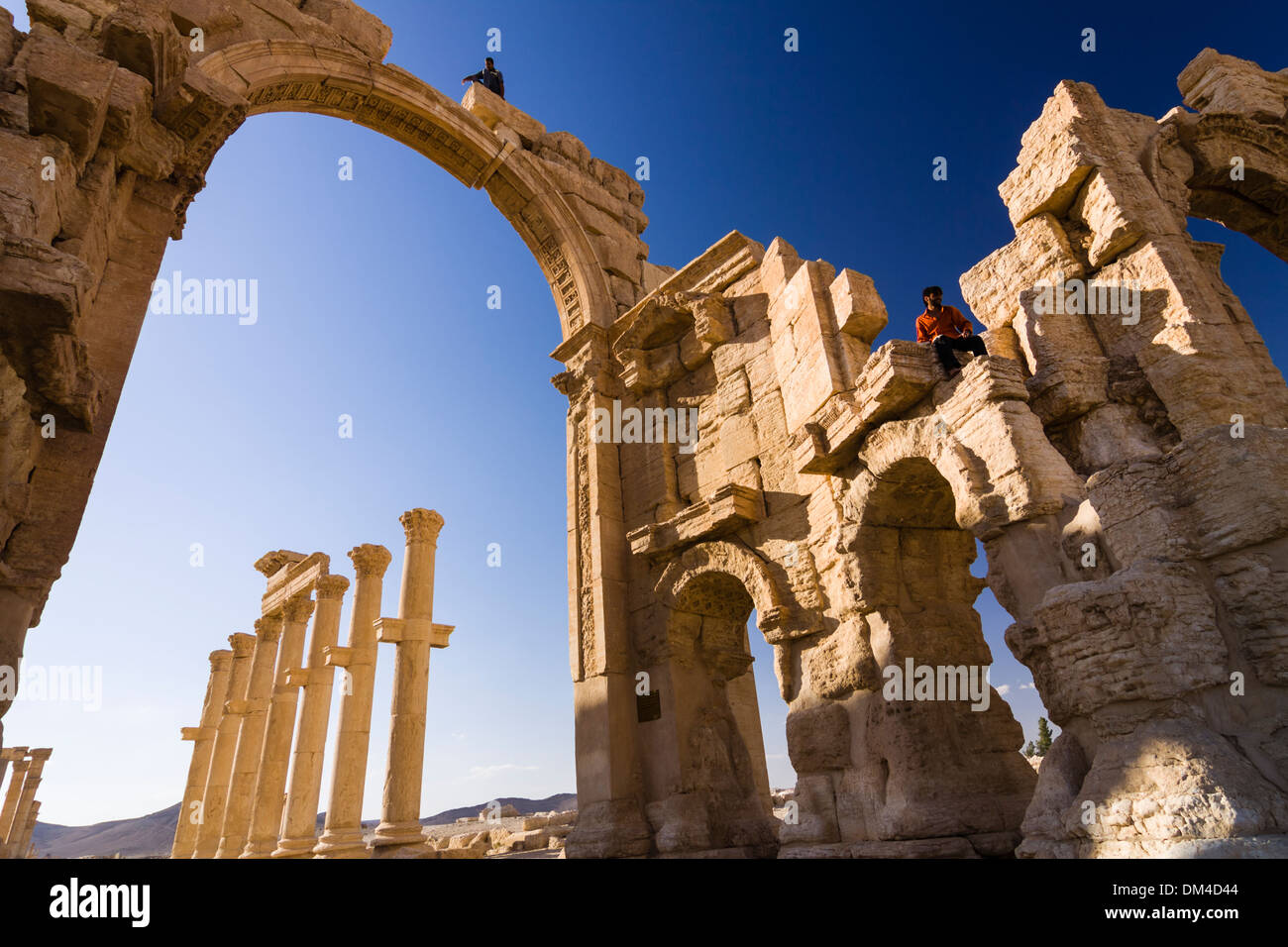 People on top of the monumental arch of the ruins at Palmyra, Syria ...