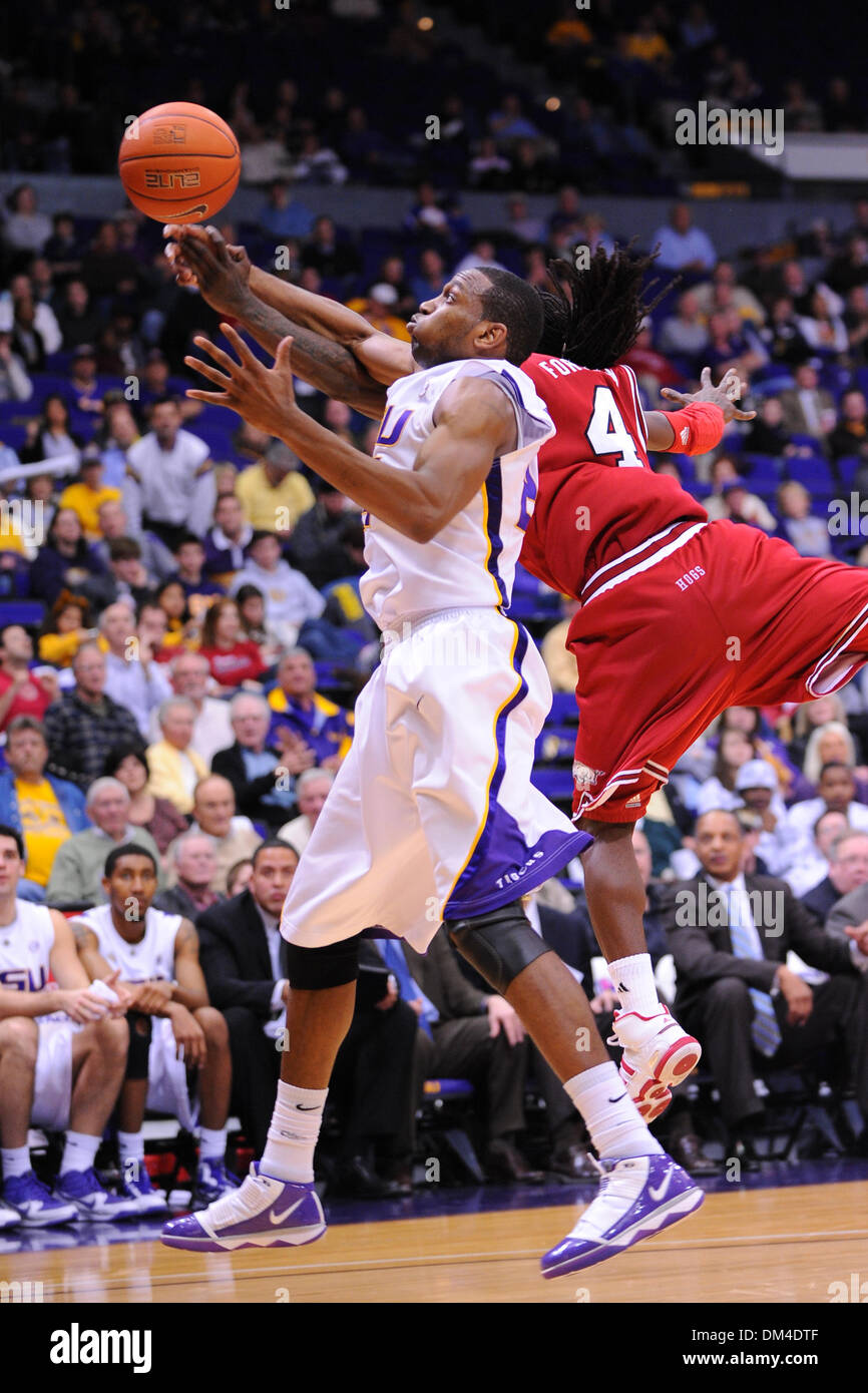 LSU forward, #24 Storm Warren, and Arkansas guard, #4 Courtney Fortson ...