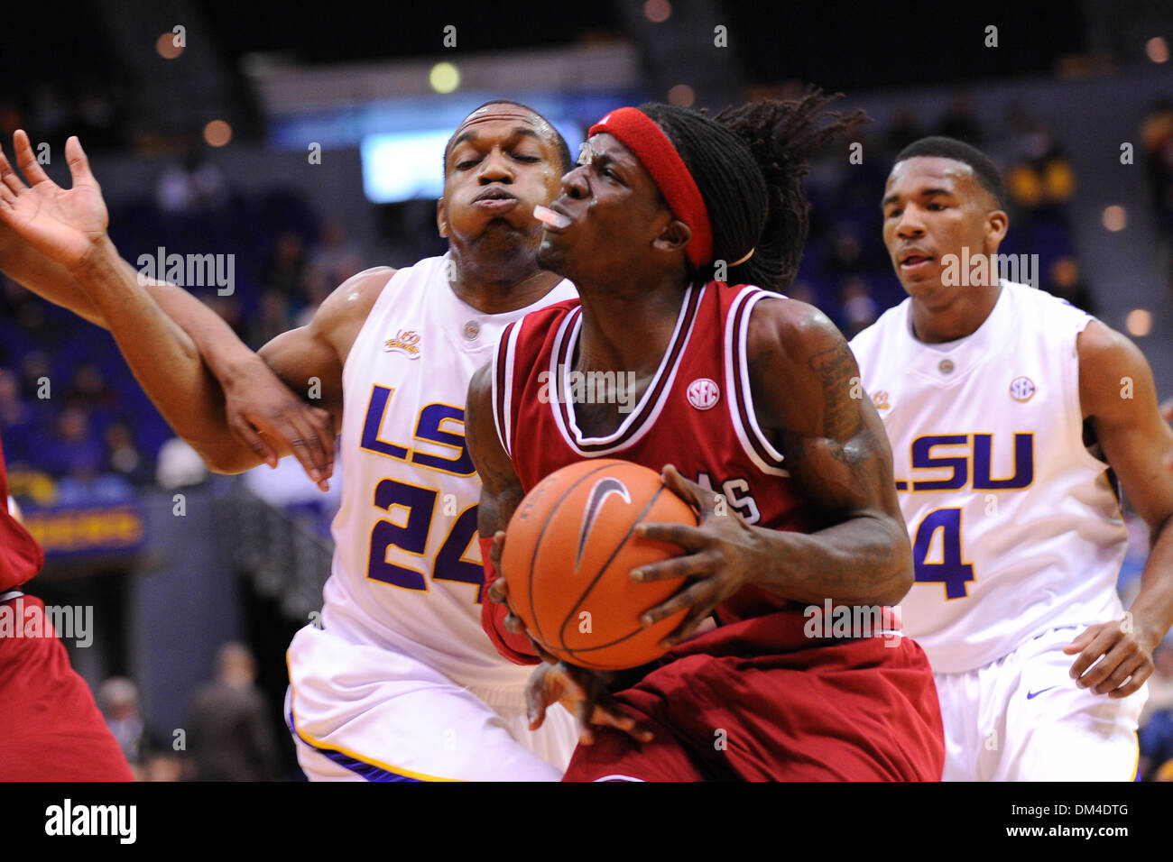 Arkansas guard, #4 Courtney Fortson, drives past LSU forward, #24 Storm ...