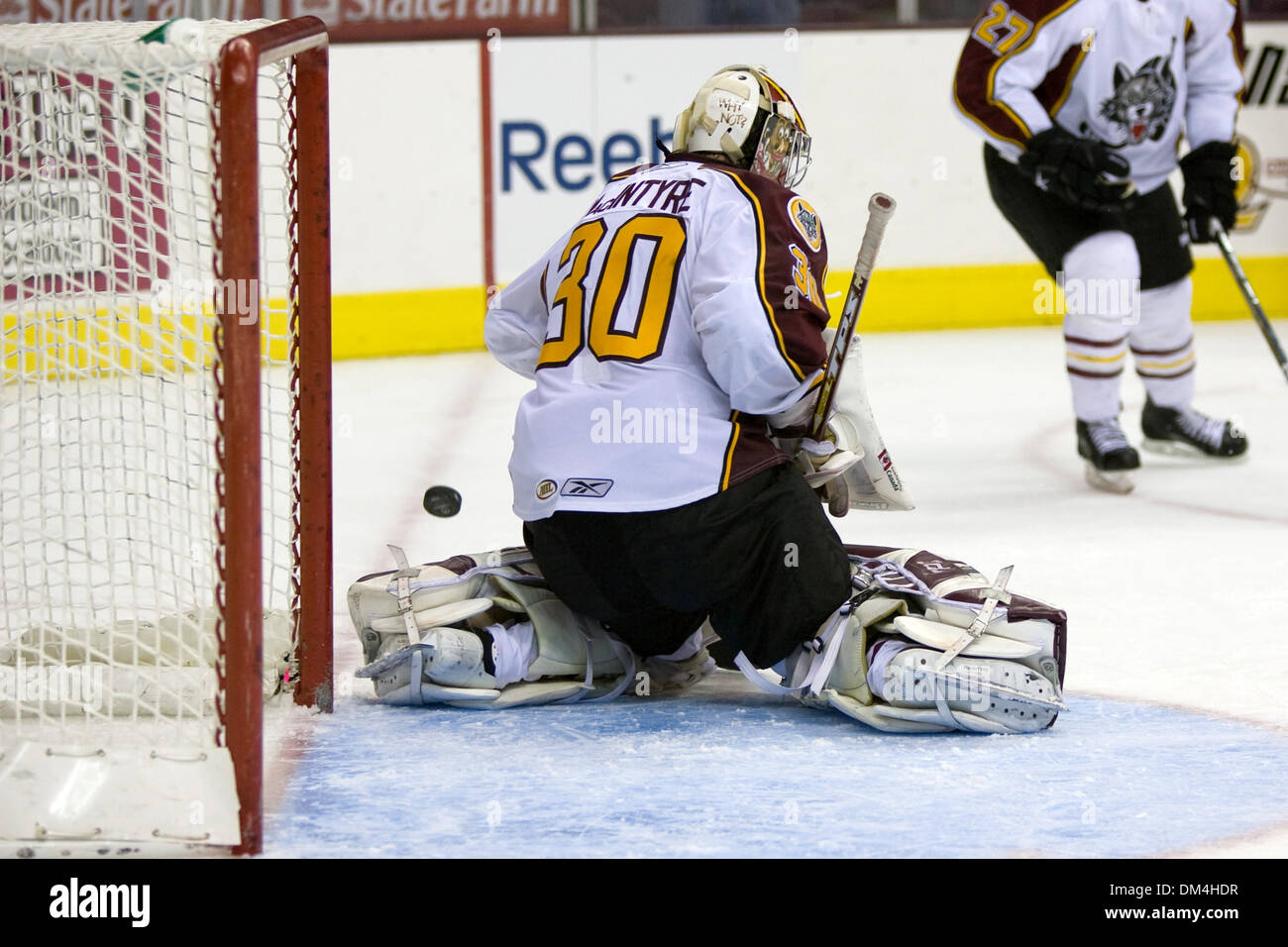 13 December 2009: A puck deflects off Chicago Wolves goalie Drew ...