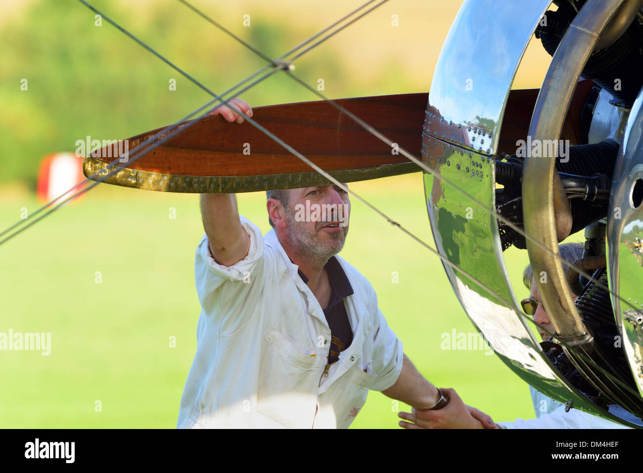 Aircraft ground crew starting the engine of an Avro Tutor biplane by ...
