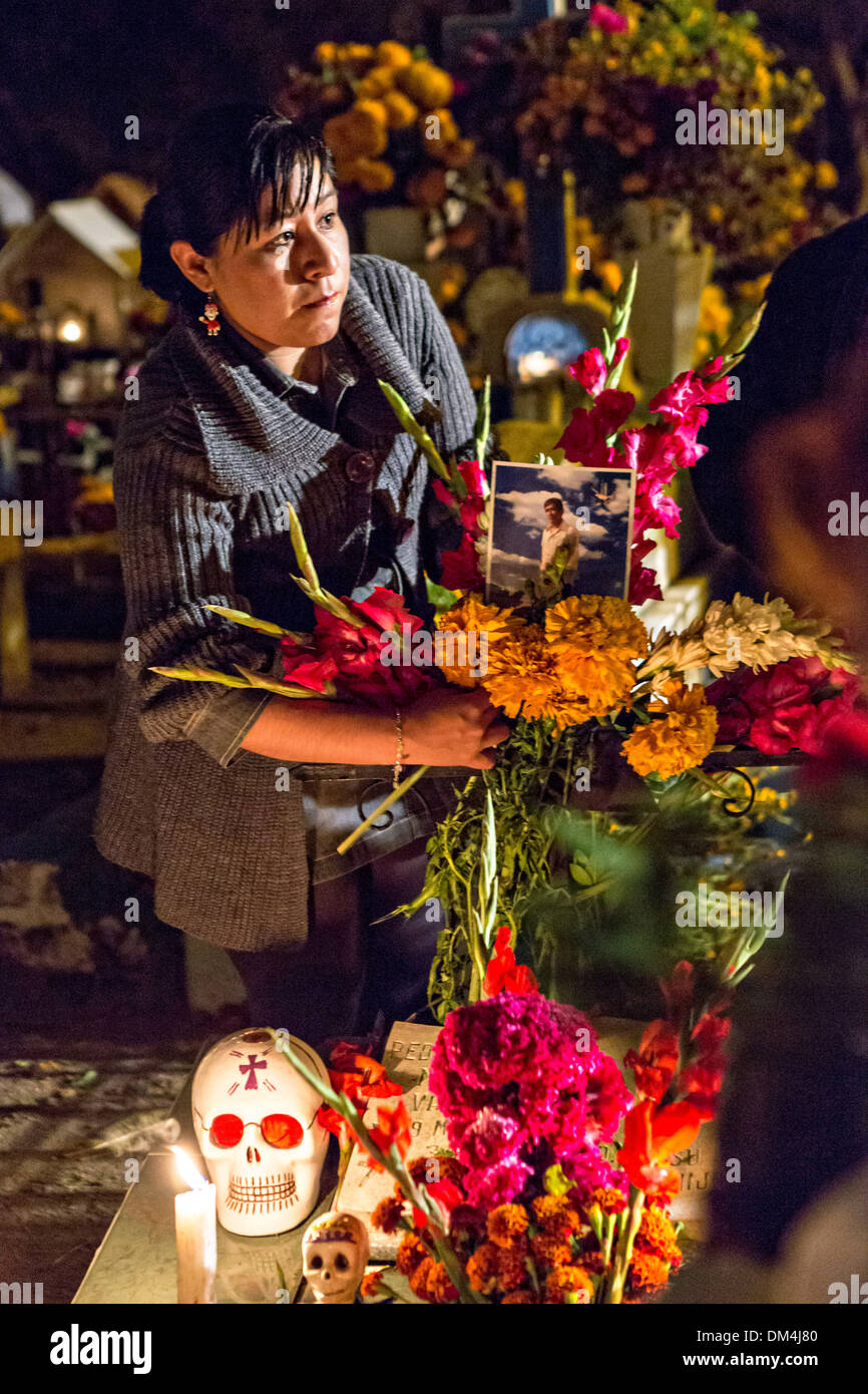 Family members light candles in honor of the dead at San Felipe de Aqua ...