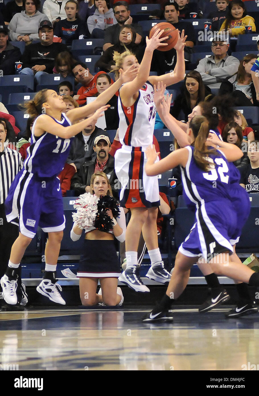 Gonzaga's Kayla Standish, middle, pulls down a rebound between Portland ...