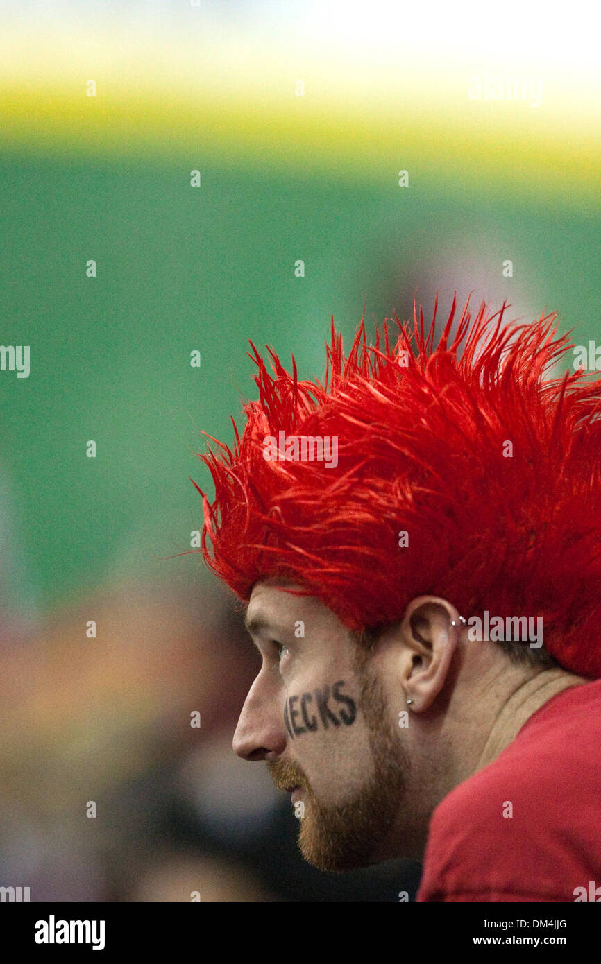 A Calgary Rednecks fan supports his team by sporting a bright red ...