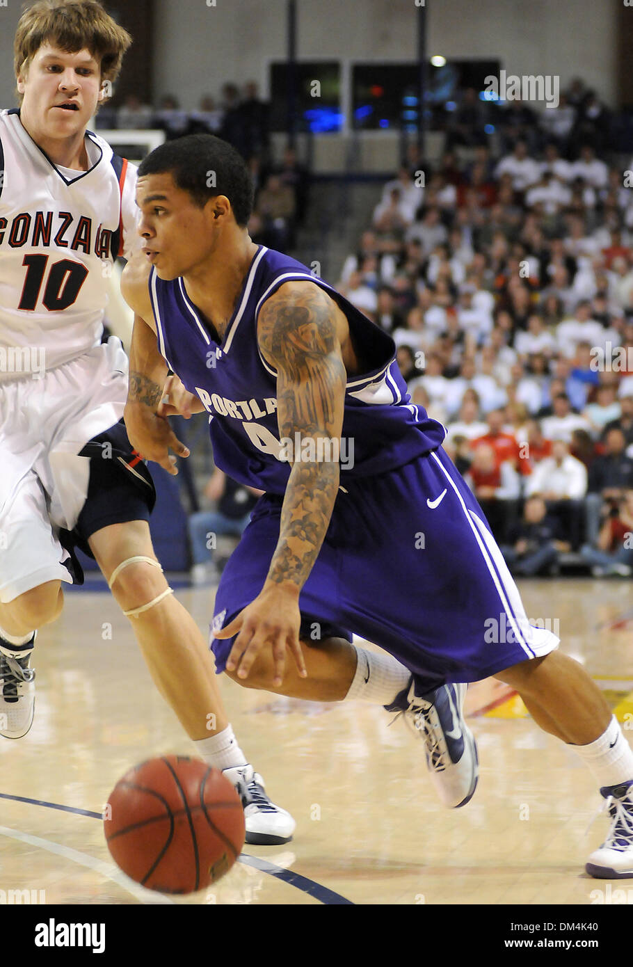 Portland's guard T.J. Campbell, right, drives the baseline past Gonzaga ...