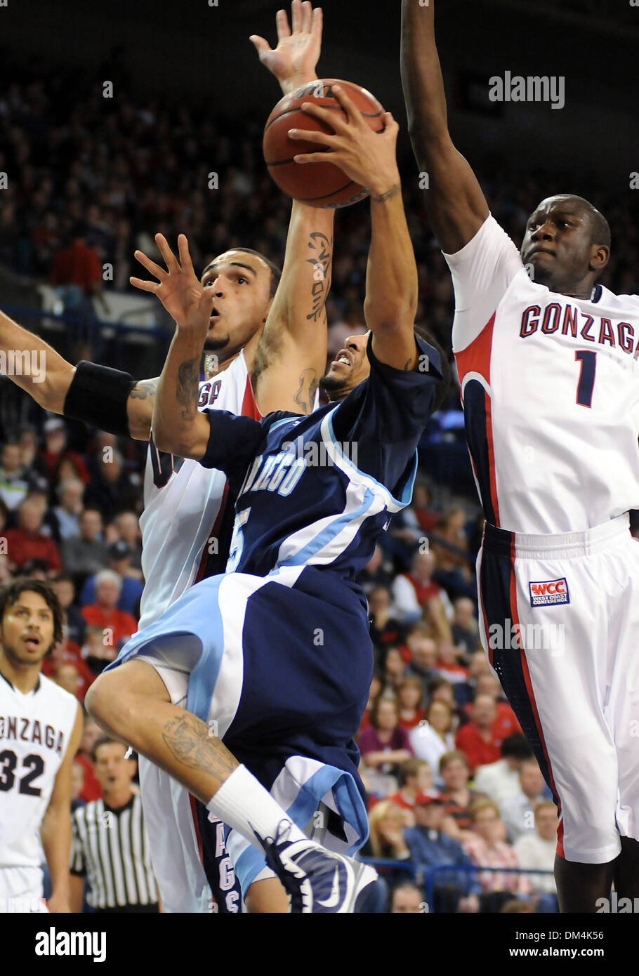 San Diego guard Patrick McCollum, center gets by Gonzaga's Robert Sacre ...