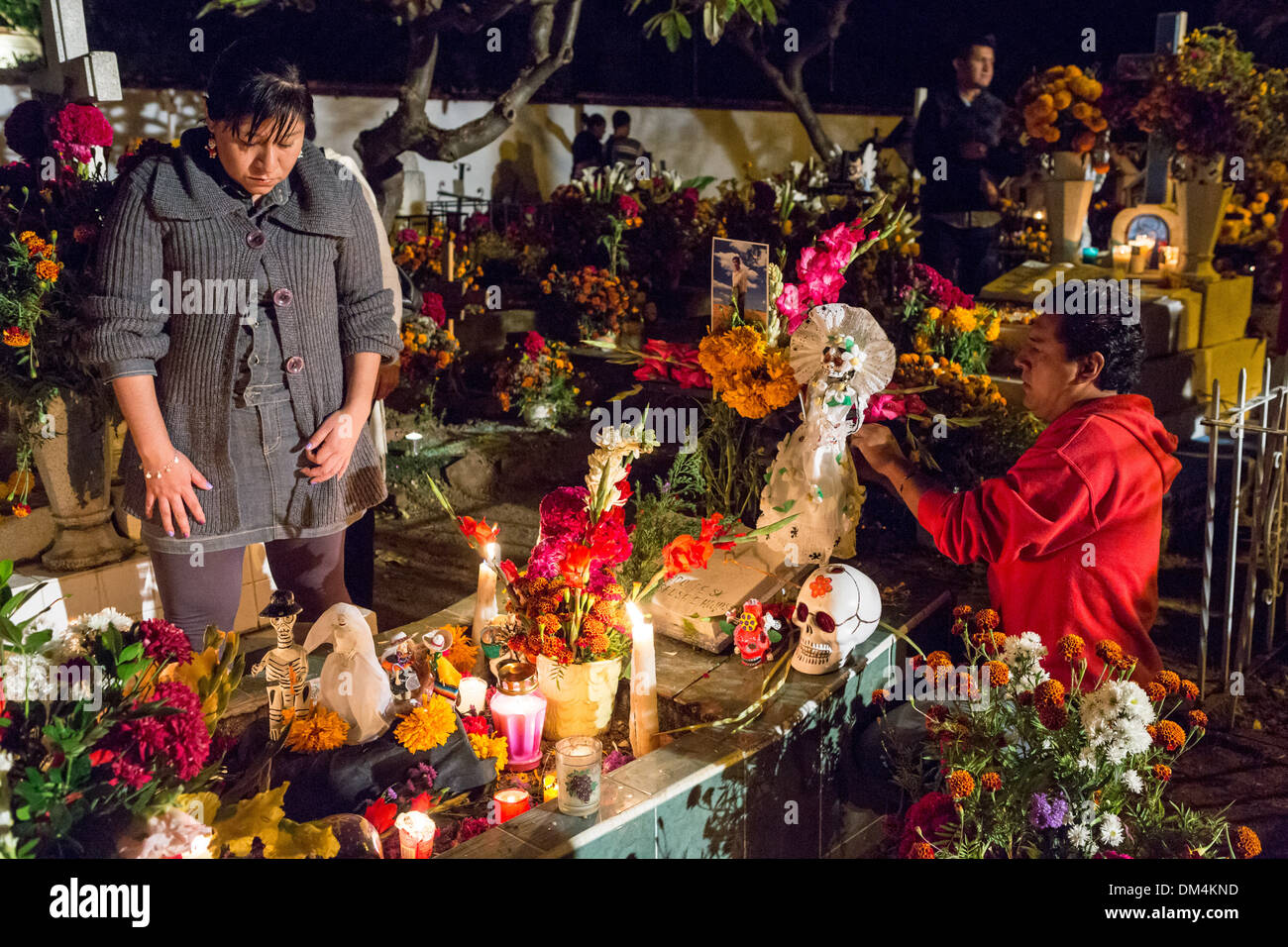 Family members light candles in honor of the dead at San Felipe de Aqua ...