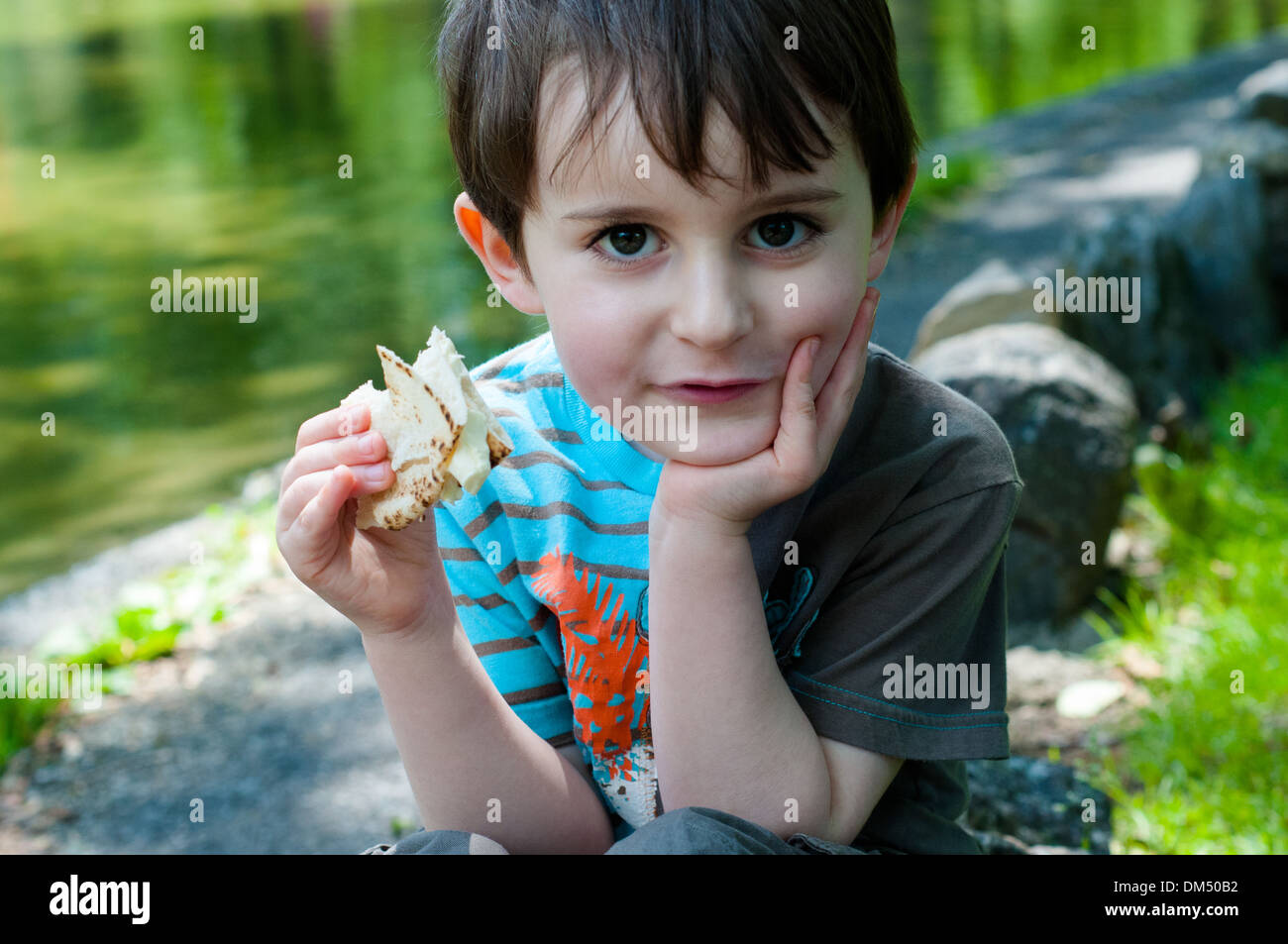 Portrait boy eating bread hi-res stock photography and images - Alamy