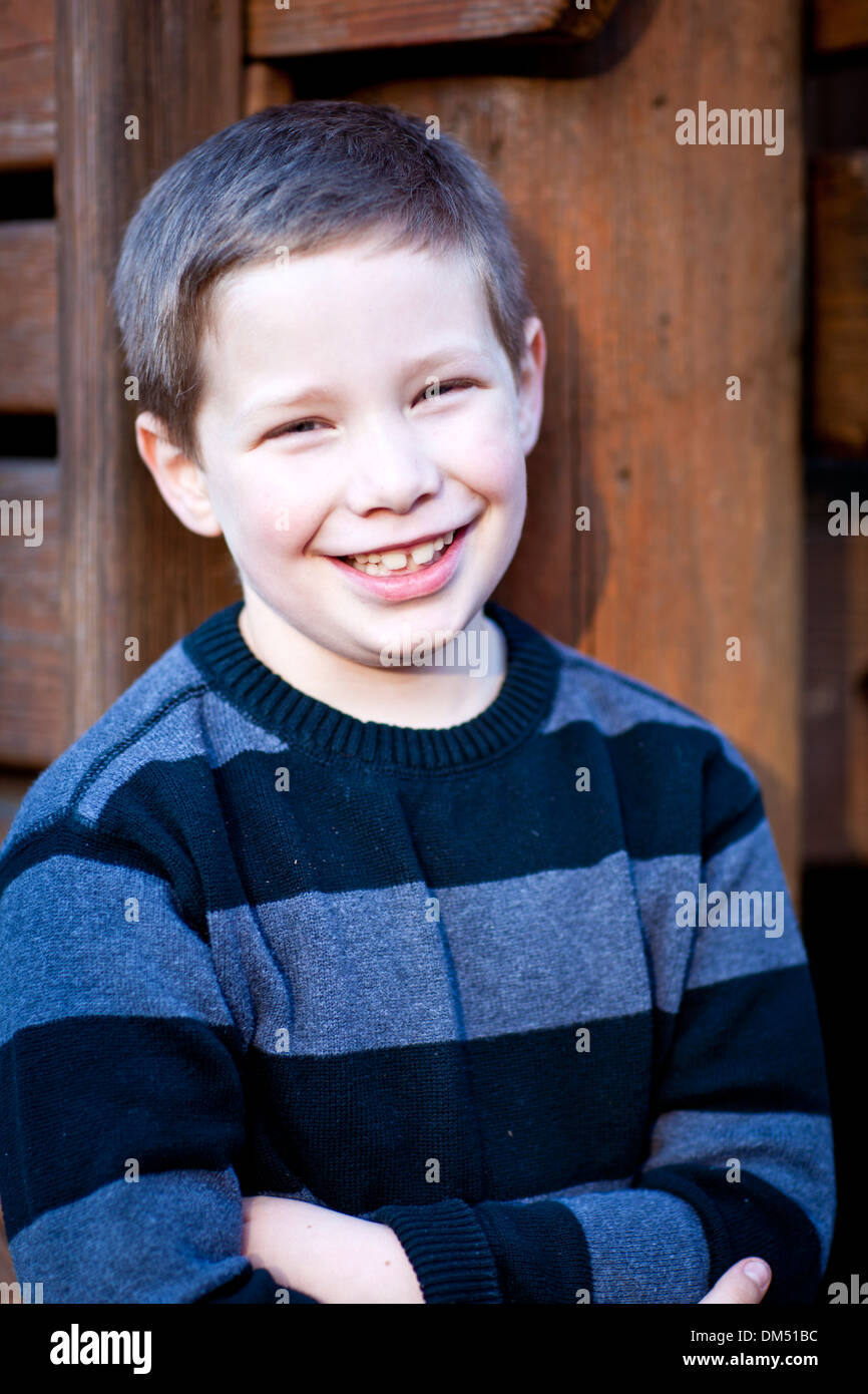 Handsome young boy standing outside portrait Stock Photo - Alamy