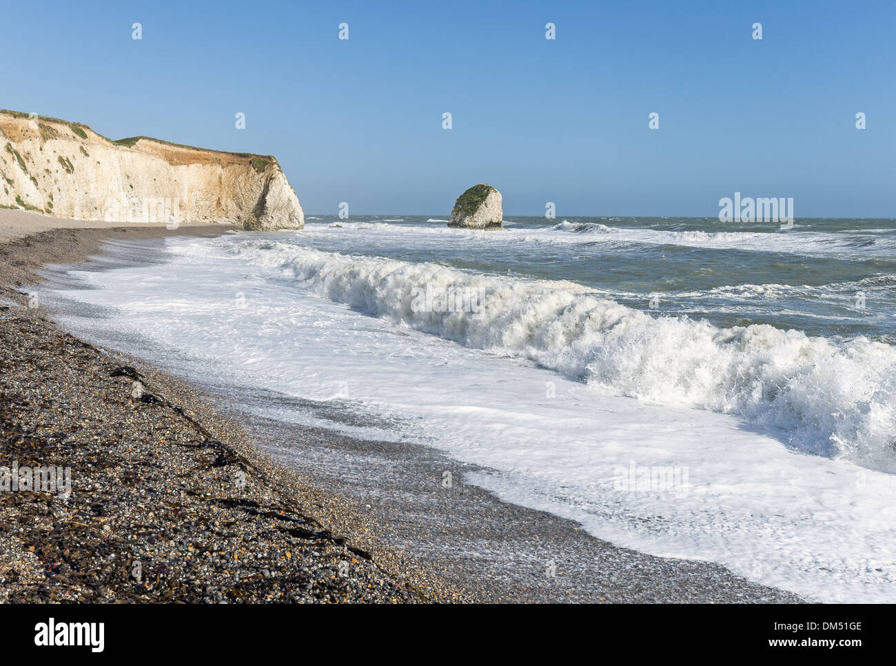 Waves crashing on Freshwater Bay showing the chalk cliffs and Stag Rock ...