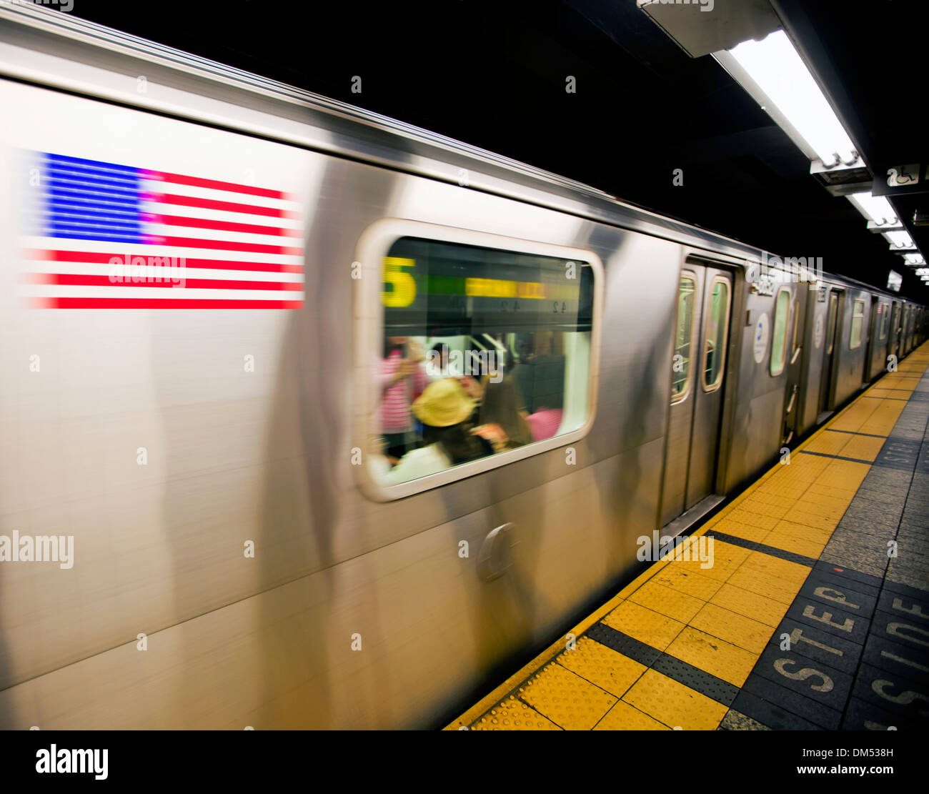 New York subway train moving through station Stock Photo - Alamy