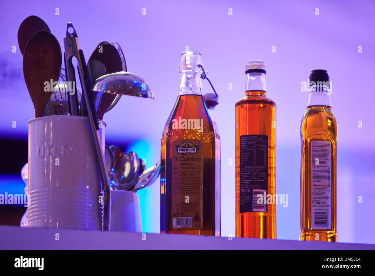 Olive oil bottles and kitchen utensils on a work surface Stock Photo ...