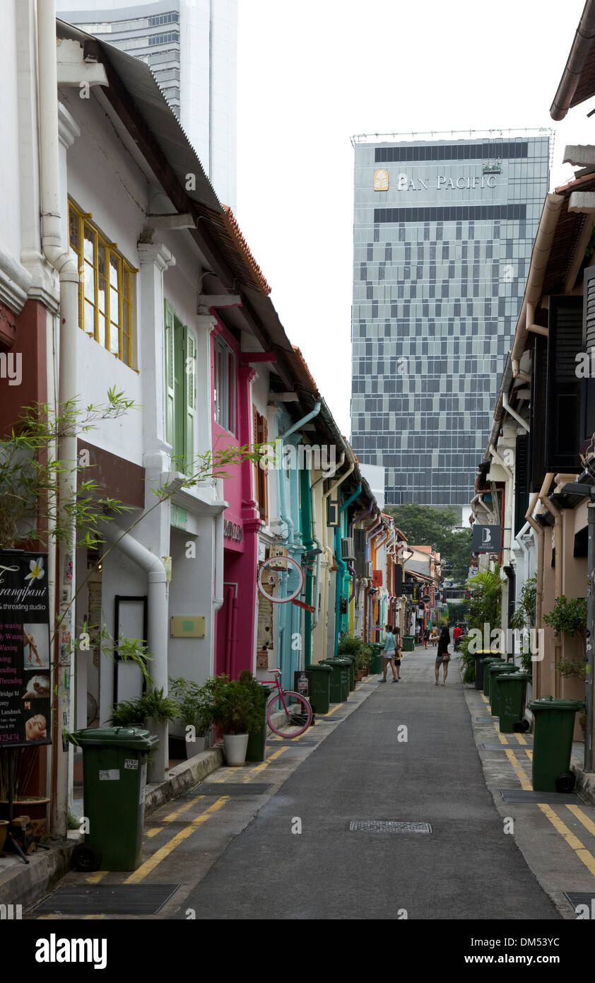 A modern high-rise building contrasts with brightly coloured older ...