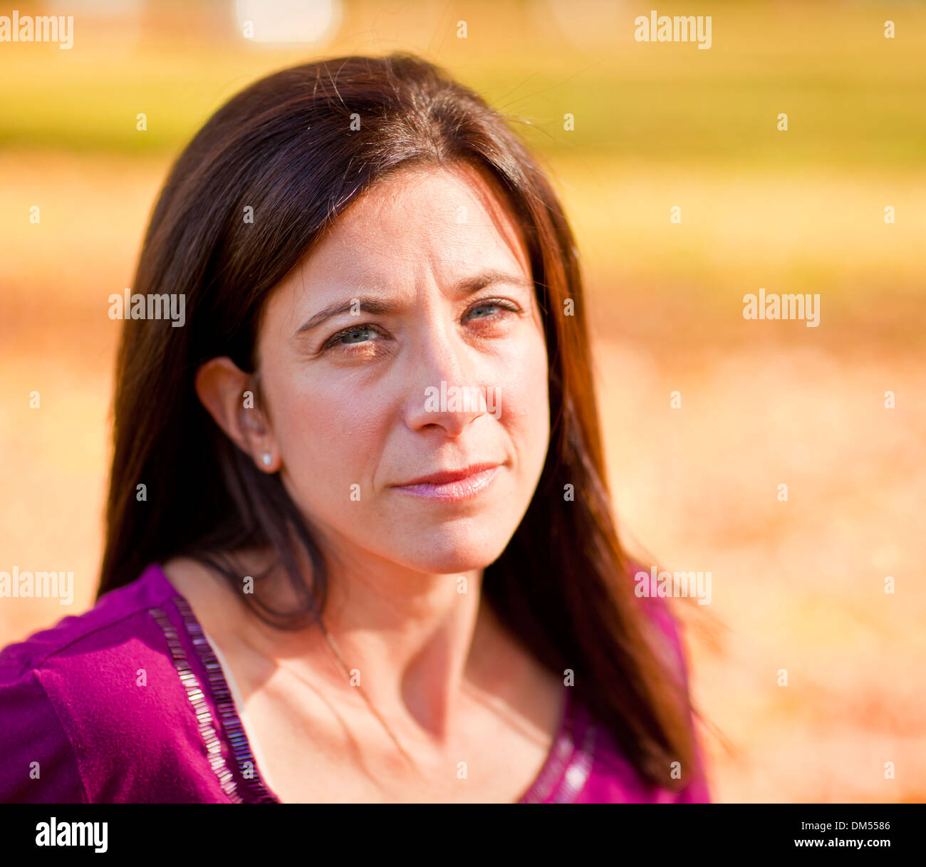 Sad beautiful woman outdoors against fall leaf background Stock Photo ...