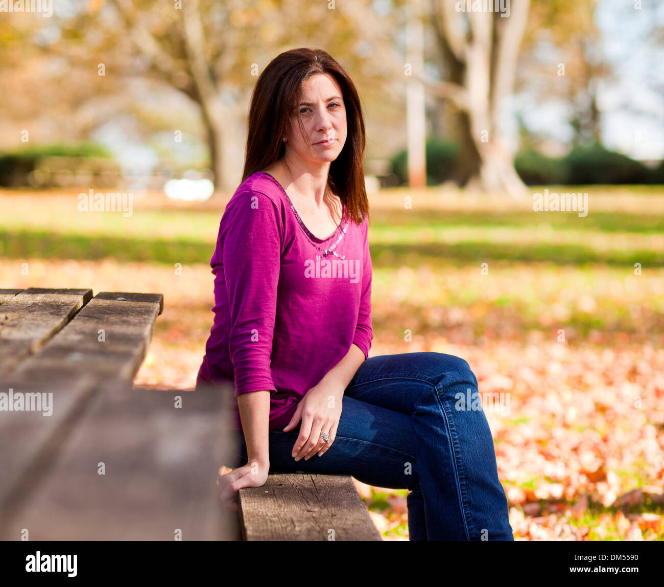 Sad beautiful woman outdoors against fall leaf background Stock Photo ...