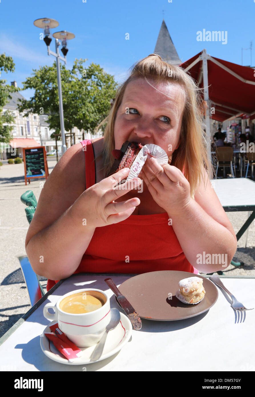 Fat woman eating cake Stock Photo - Alamy