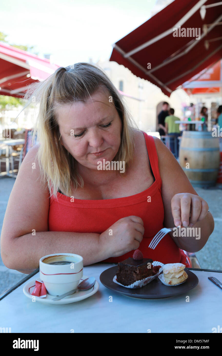 Fat woman eating cake hi-res stock photography and images - Alamy