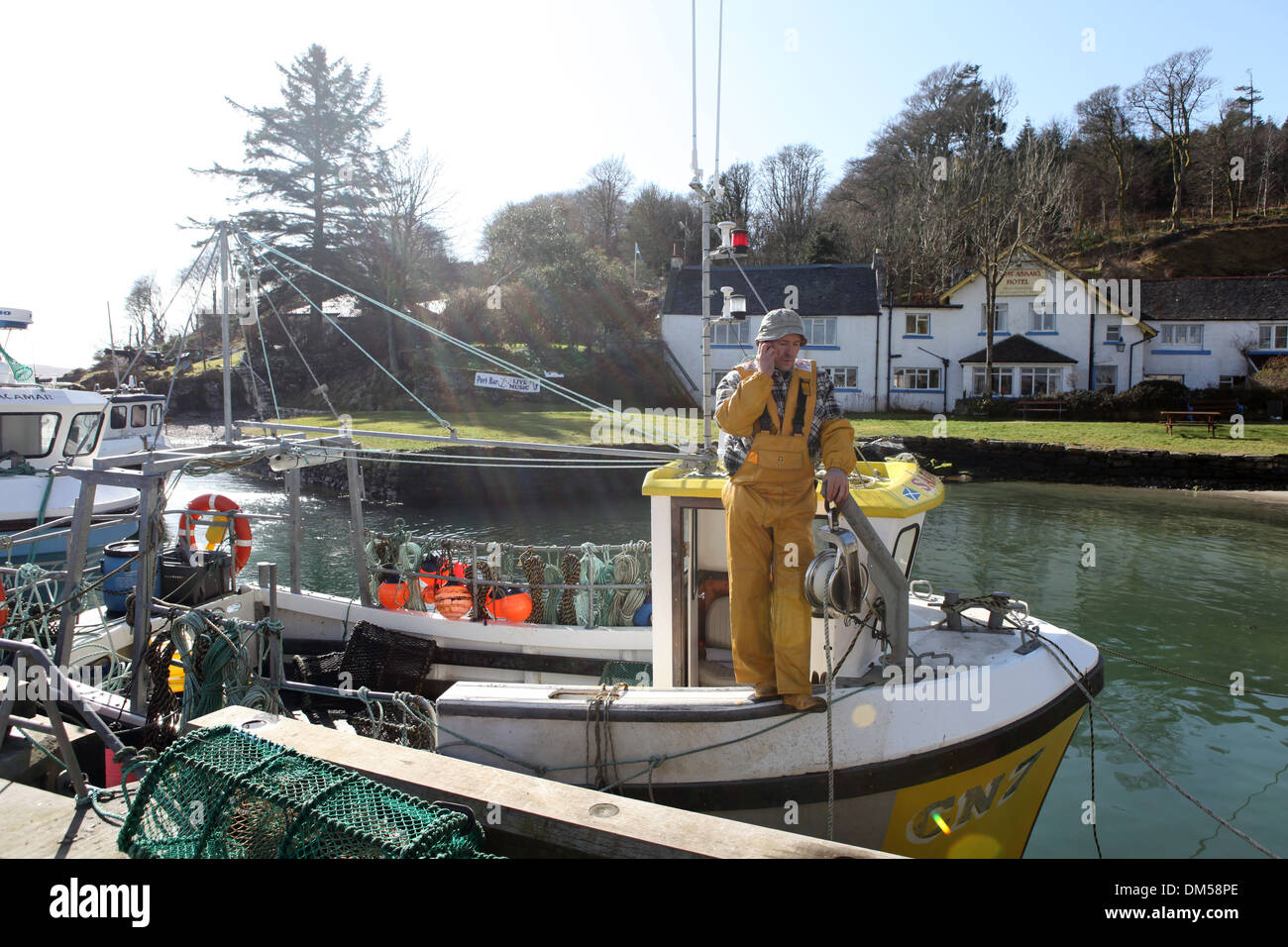 Fisherman in a fishing boat. Isle of Islay, Scotland Stock Photo - Alamy