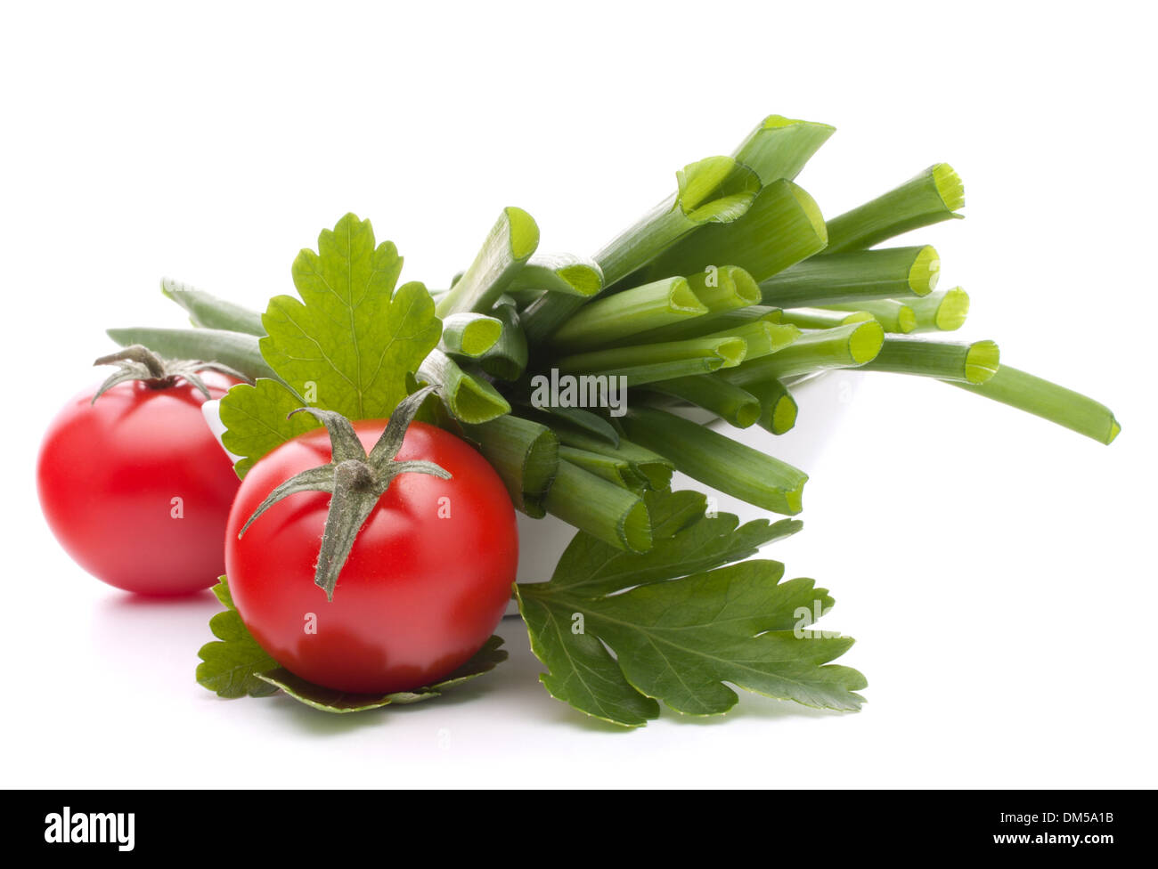 Spring onions and cherry tomato in bowl isolated on white background ...