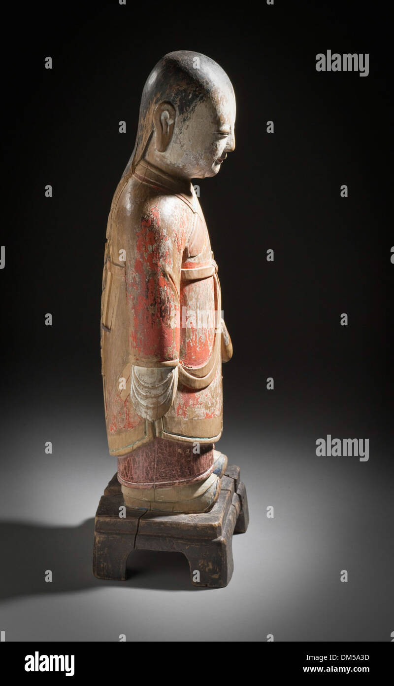 This figure, titled 'Altar Attendant (Tongja) Holding a Book,' depicts ...