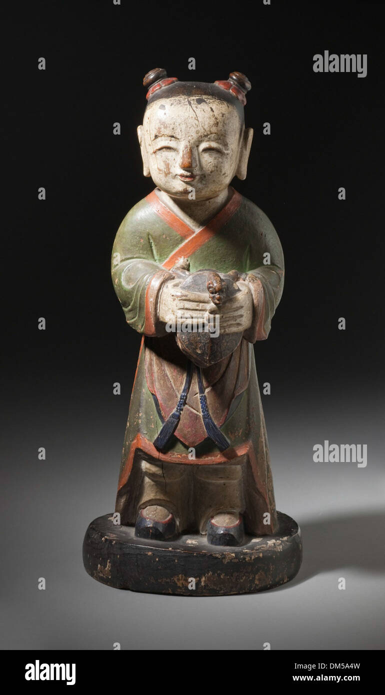 This altar attendant (Tongja) holding a turtle is a traditional figure ...