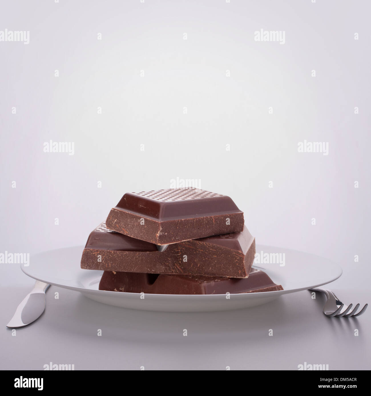 Chocolate bars stack on plate. Unhealthy eating concept Stock Photo - Alamy