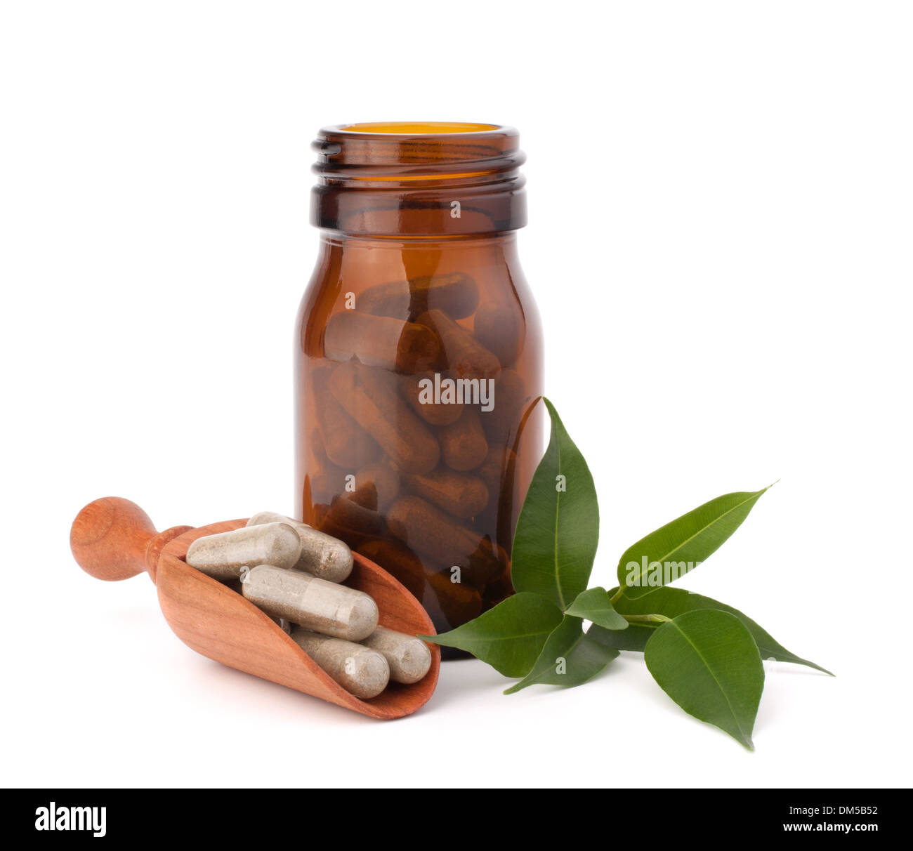 Herbal drug capsules in brown glass bottle isolated on white background ...