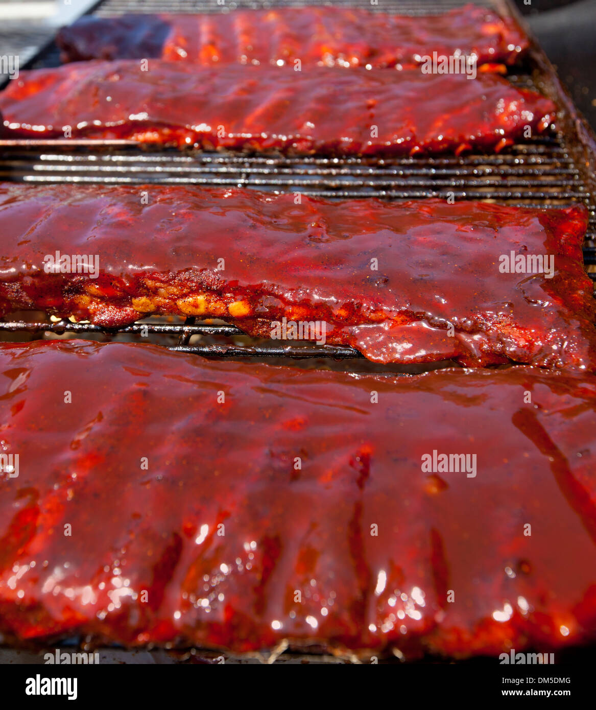 Racks of BBQ ribs on a hot grill Stock Photo - Alamy