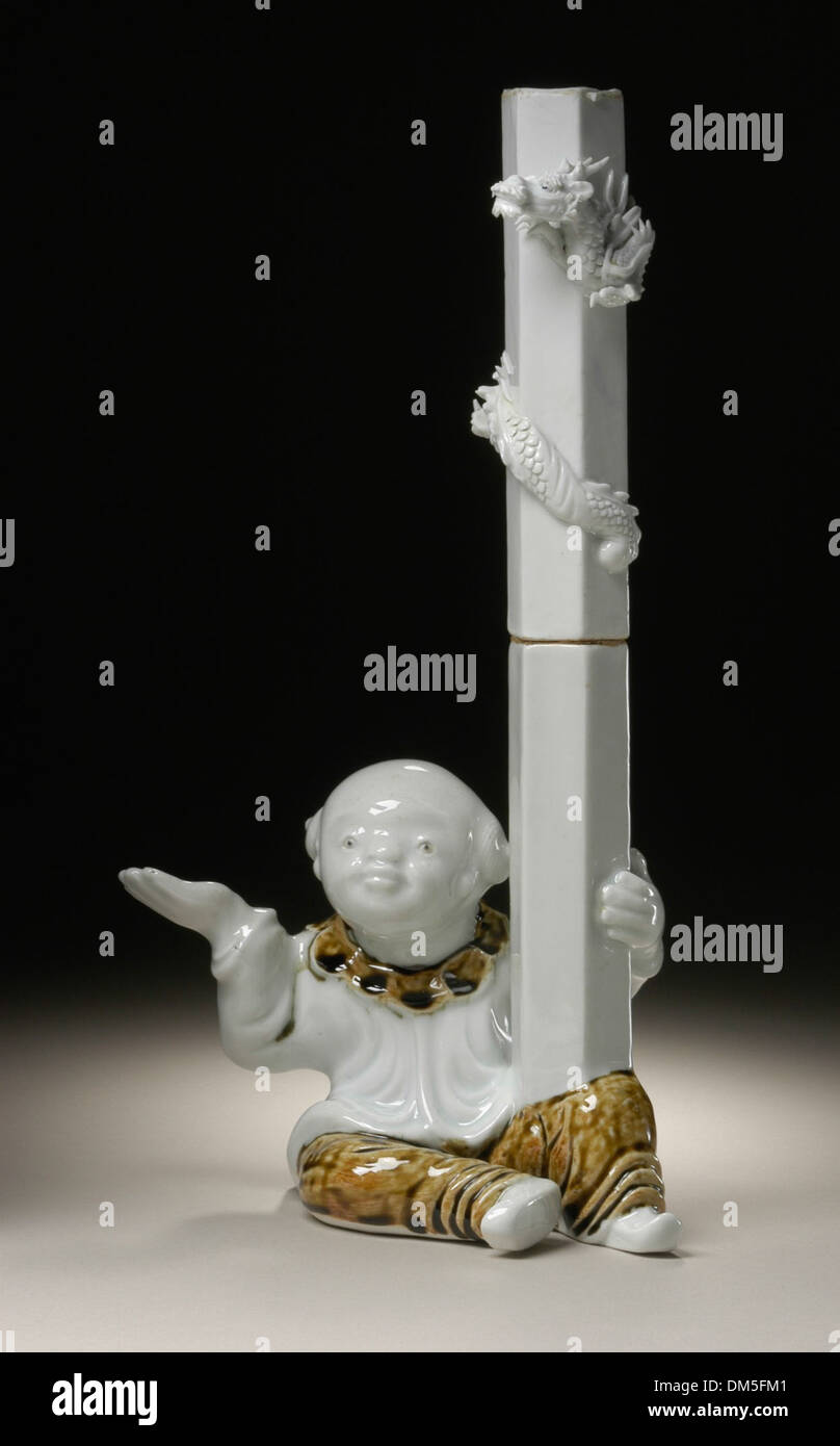 This photograph captures a Chinese boy (karako) holding a candlestick ...