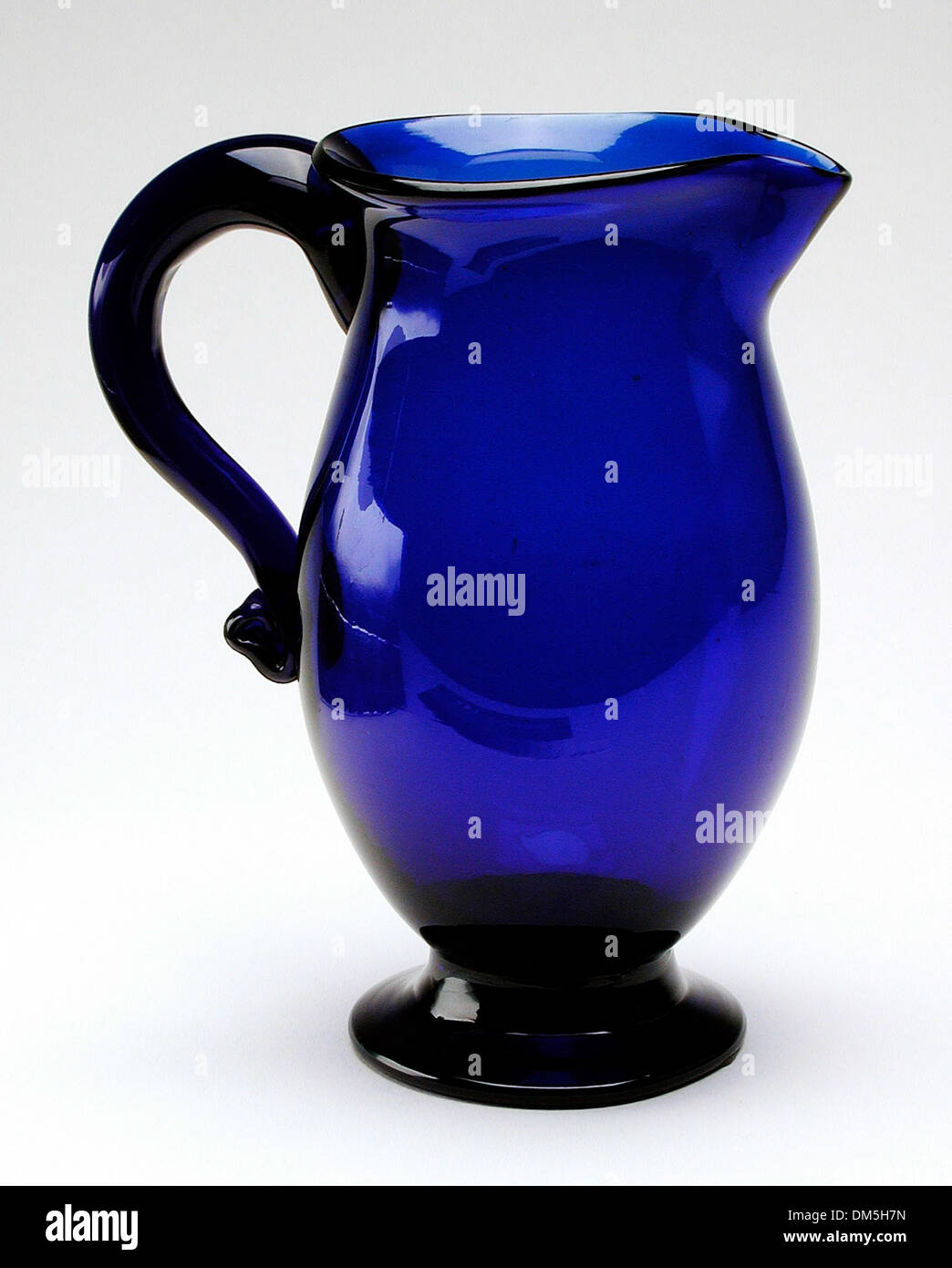 This cream jug is a fine example of classic ceramic design, featuring ...