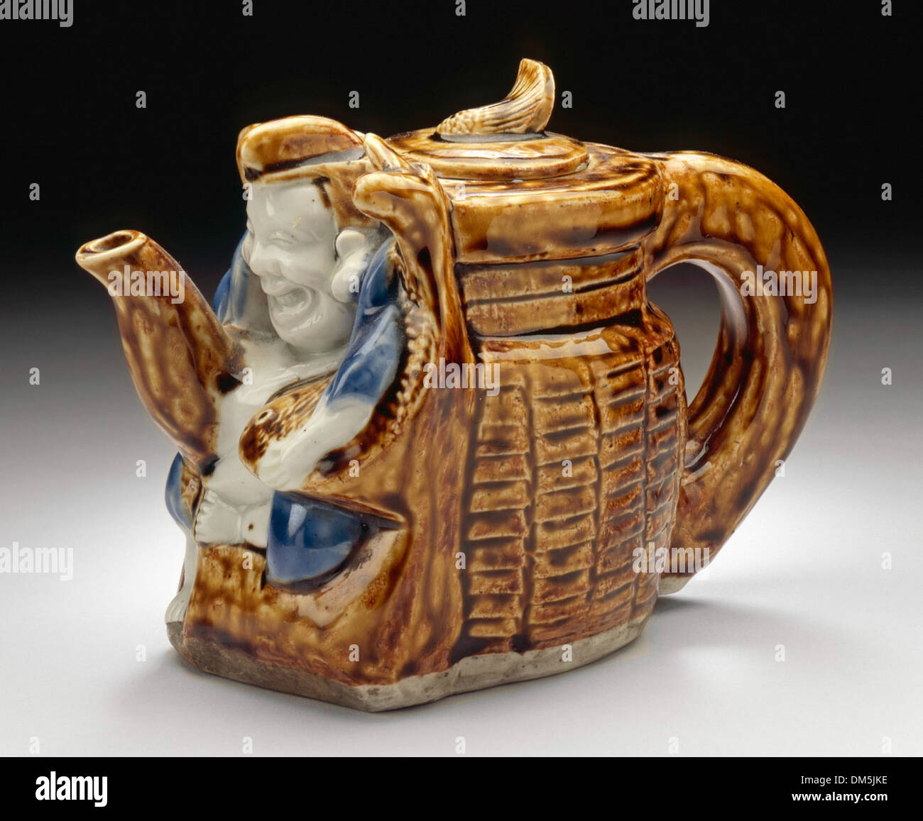 This teapot or ewer is designed in the shape of Ebisu, the Japanese god ...