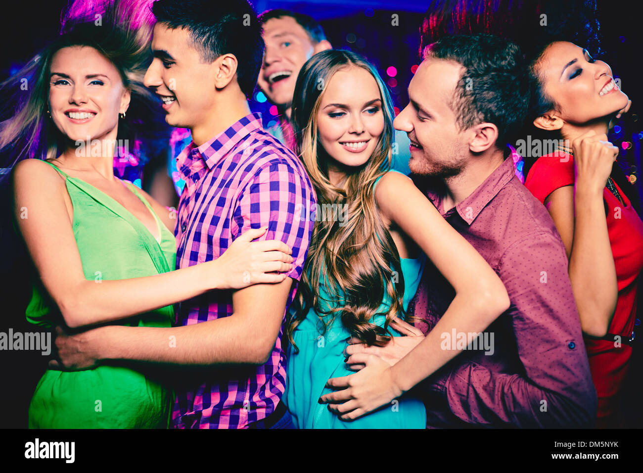 Happy young friends dancing in the nightclub Stock Photo - Alamy
